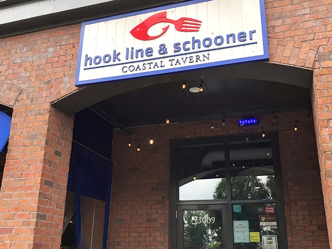 The patio at Hook Line & Schooner beckons like a seafood siren, with hanging plants and string lights creating that "vacation in your hometown" vibe.
