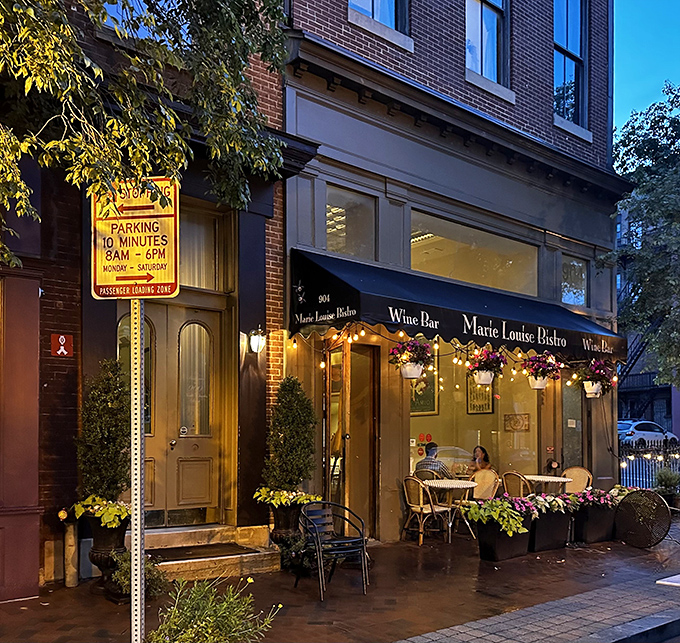 The charming exterior of Marie Louise Bistro glows with warm invitation as evening falls on Baltimore's Mount Vernon neighborhood.