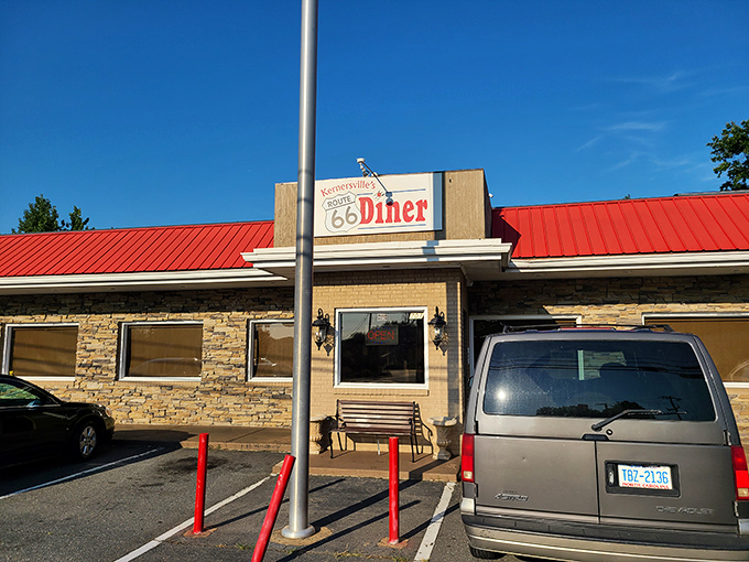 The iconic red roof and stone facade of Route 66 Diner beckons hungry travelers like a roadside oasis in Kernersville.