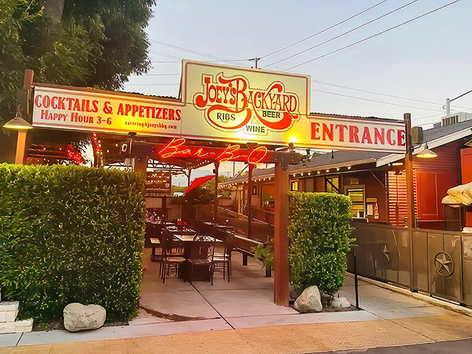 The rustic charm of Joey's exterior isn't trying to impress anyone—which is exactly why it does. Simple wooden benches under that iconic red umbrella promise authentic BBQ bliss.