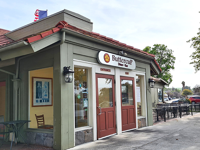 The charming exterior of Buttercup beckons with its burgundy doors and cozy stone accents&mdash;like a storybook cottage that happens to serve incredible eggs Benedict.