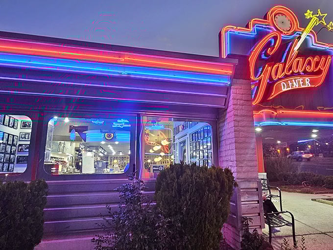 That iconic neon sign beckons like a beacon of breakfast hope on Route 66. The cosmic promise of comfort food awaits beneath those glowing letters.