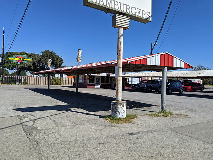 The red and white awning beckons like a time portal to simpler days. Keller's Drive-In stands proudly against the Dallas sky, promising nostalgic delights.
