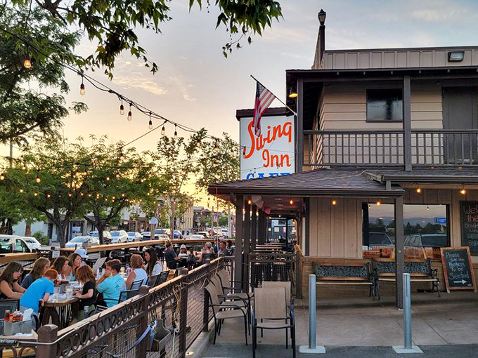 The Swing Inn's exterior beckons with its rustic charm and vibrant red umbrellas &ndash; like a Western saloon that decided to get serious about brunch.