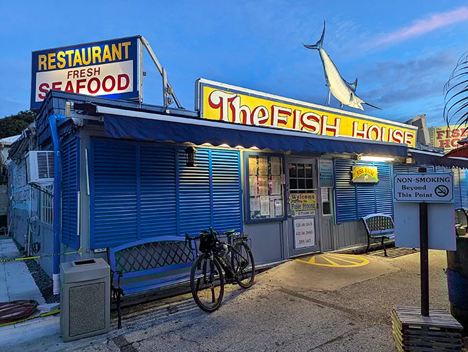 The iconic blue exterior of The Fish House Encore stands proudly in Key Largo, complete with a marlin that seems to say, "Yes, we know our seafood."