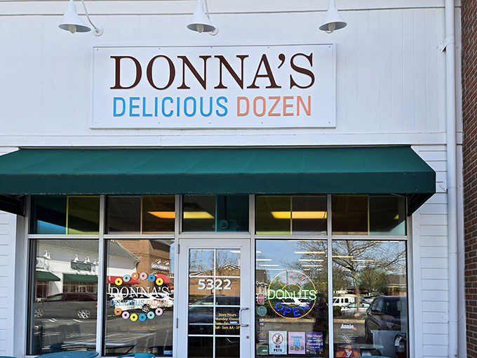 The iconic green awning and crisp white facade of Donna's Delicious Dozen welcomes donut pilgrims like a beacon of sugary salvation in Columbus.