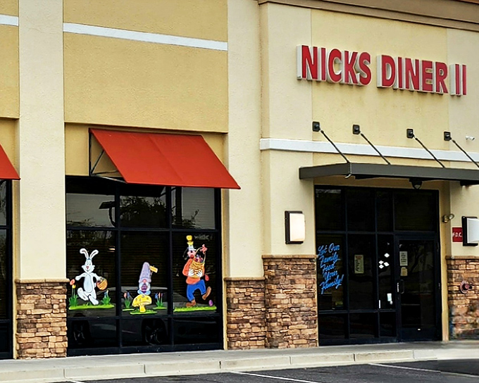 Nick's Diner II announces itself with golden letters against desert beige, those red awnings practically whispering "come in, the air conditioning is glorious."
