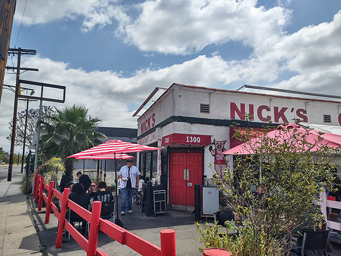 The iconic white building with bold red trim stands like a time capsule on North Spring Street, beckoning hungry Angelenos with its no-nonsense charm.
