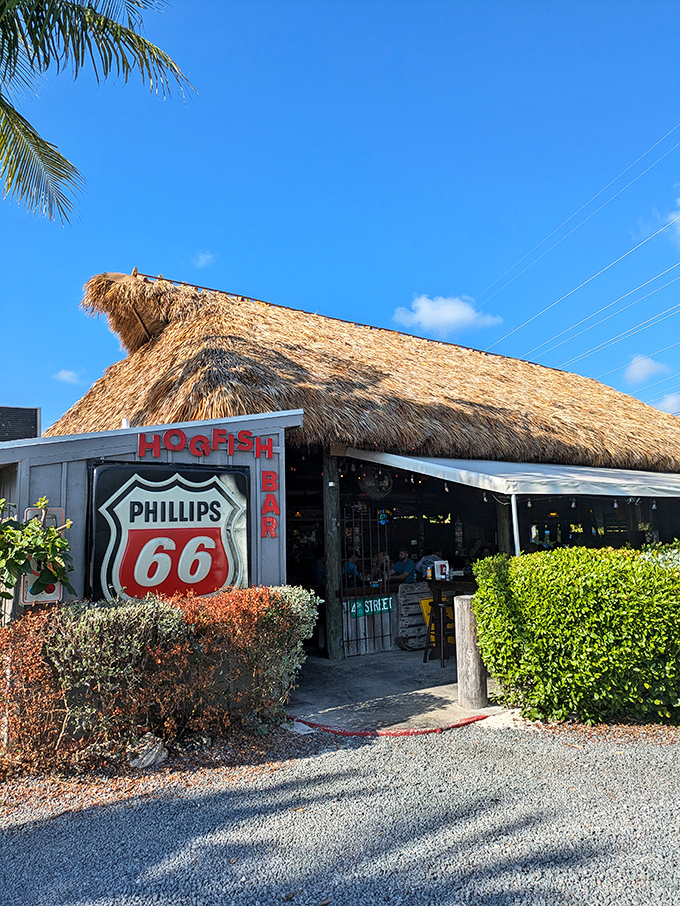 The thatched-roof entrance to Hogfish Bar & Grill looks like a postcard from Old Florida—before developers discovered paradise and added valet parking.