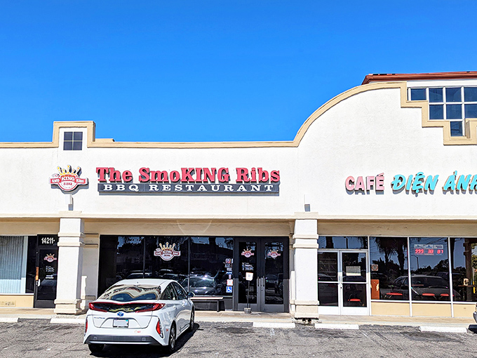 The unassuming storefront belies the smoky treasures within. Like finding a hidden treasure map, that bold red sign promises delicious adventures ahead.