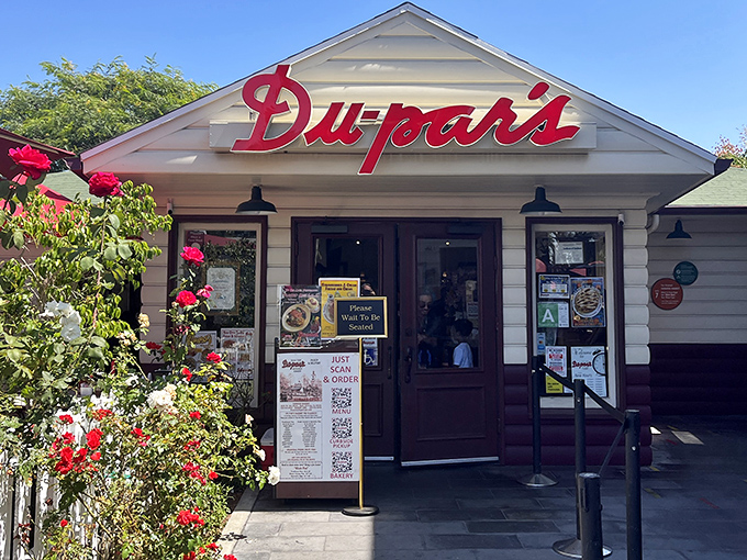 That iconic red neon sign isn't just announcing a restaurant&mdash;it's signaling your imminent reunion with pancake perfection at the edge of LA's historic Farmers Market.