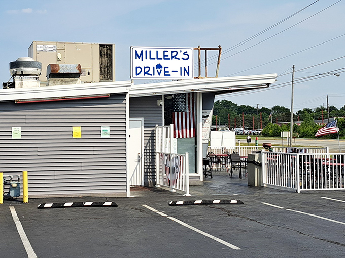 The unassuming blue-gray exterior of Miller's Drive-In stands as a time capsule of Americana, where culinary memories are made one scoop at a time. 