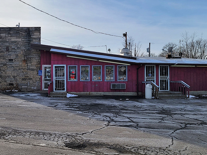 The stone facade and bright red exterior of Porky's stands like a culinary time capsule, preserving flavors that chain restaurants can only dream of replicating.