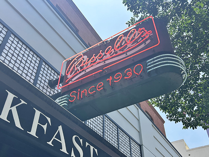 The iconic red neon sign beckons hungry Pasadenans like a breakfast lighthouse, promising comfort and nostalgia since 1930.