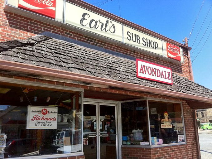 Earl's Sub Shop at sunset &ndash; where the humble brick exterior and vintage Coca-Cola signs promise authentic deliciousness that transcends the modest surroundings.