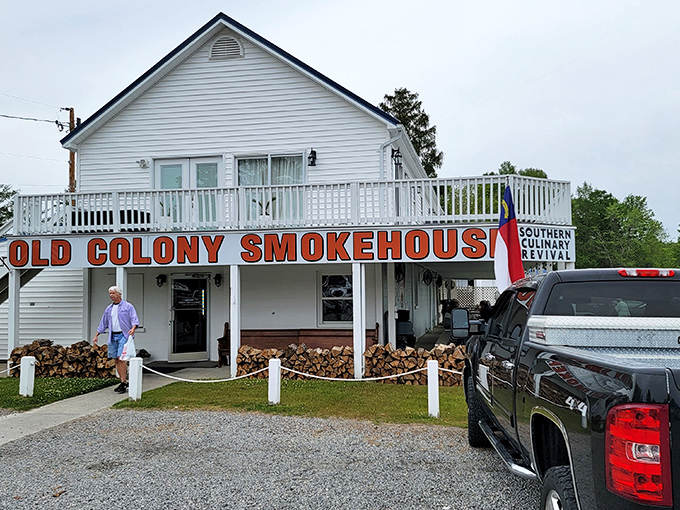 The weathered wooden sign swinging gently in the breeze promises smoked meat nirvana. Like a lighthouse for hungry travelers, it beckons.