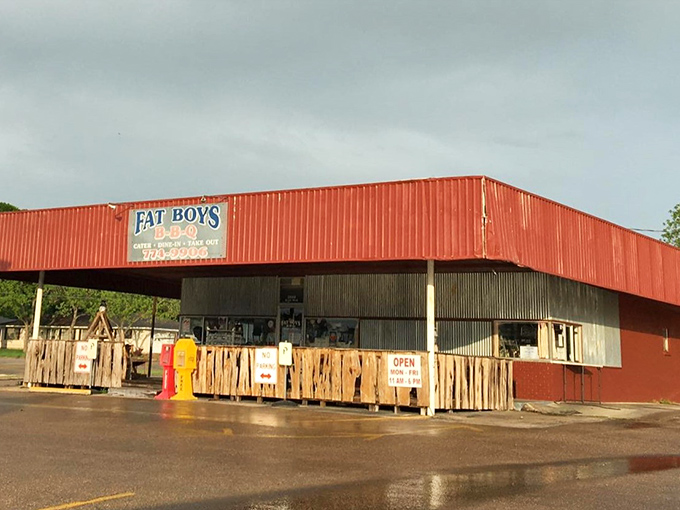 The bright red exterior of Fat Boy's BBQ stands as a beacon of hope for hungry travelers. No fancy frills, just the promise of smoky perfection within.