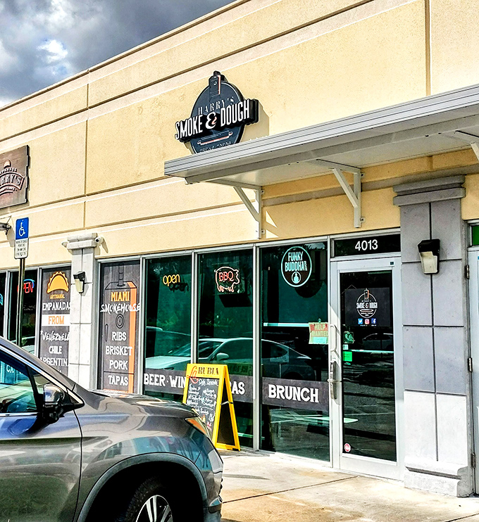 The unassuming storefront hides culinary treasures like a speakeasy for smoked meats. That neon BBQ sign is basically a bat signal for hungry Miamians.
