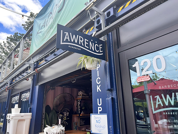 The blue shipping container exterior of Lawrence Barbecue beckons like a siren song for smoke-seekers. Modern design meets traditional BBQ sensibilities.