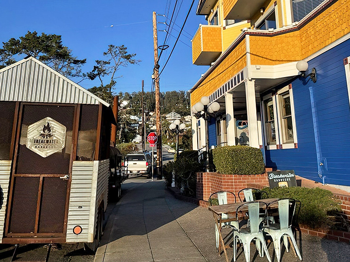 The unassuming exterior of Breakwater Barbecue hides in plain sight, with its smoker standing guard like a sentinel of savory promises to come.