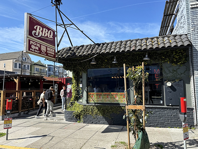 The charming exterior of 4505 Burgers & BBQ beckons with its vintage sign and vine-covered facade&mdash;a carnivore's oasis in San Francisco's urban landscape.
