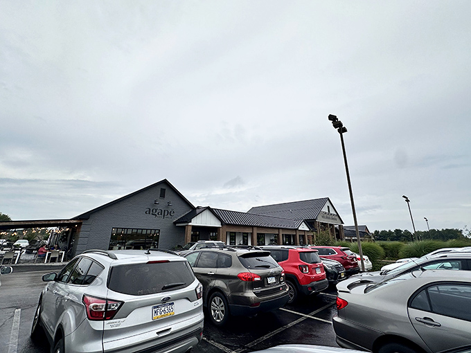 The modern farmhouse exterior of Agapē Cafe & Grille stands proudly against Pennsylvania's blue skies, promising culinary adventures within those charcoal-gray walls.
