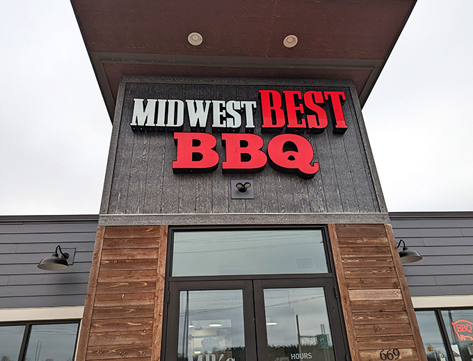 The bold red letters against dark siding announce what awaits inside: barbecue worth crossing county lines for. No fancy frills needed.