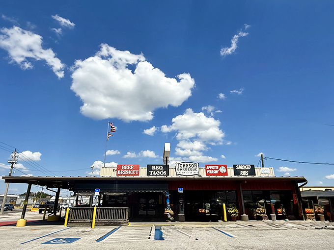 The unassuming exterior of Johnson Barbeque stands proudly under Florida's blue sky, a humble temple of smoke where BBQ dreams come true.