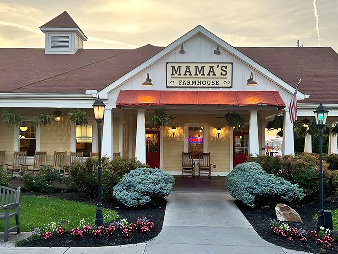 The classic white farmhouse exterior with its inviting porch and rocking chairs isn't just architecture&mdash;it's a promise of the comfort waiting inside.