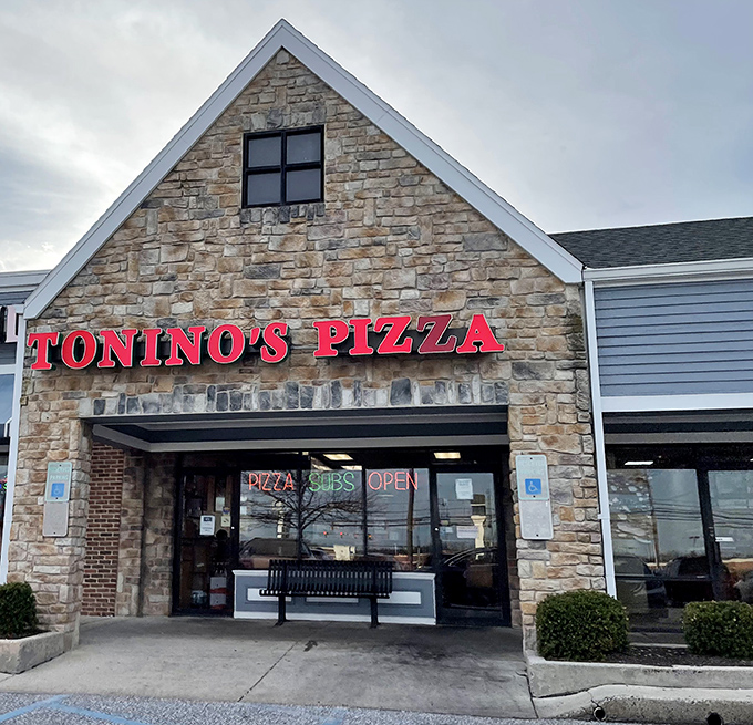 The stone facade of Tonino's Pizza glows with promise, like a beacon of comfort food calling you home after a long day.