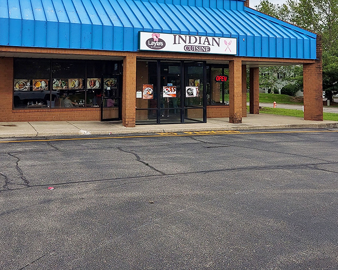 The bright blue roof of Layla's Kitchen stands out like a culinary beacon, promising spice-filled adventures within this unassuming Columbus strip mall.