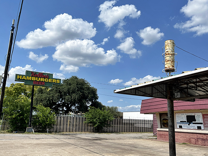 The red and white awning beckons like a time portal to simpler days. Keller's Drive-In stands proudly against the Dallas sky, promising nostalgic delights.