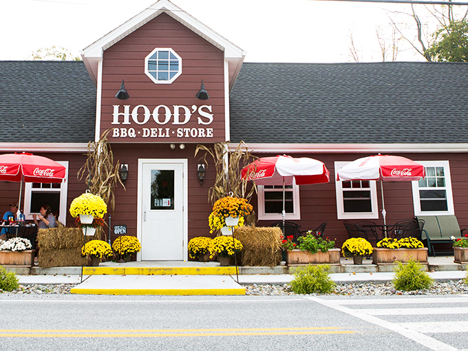 The burgundy farmhouse exterior with its cheerful yellow walkway and seasonal mums isn't just curb appeal&mdash;it's a promise of homestyle comfort waiting inside.