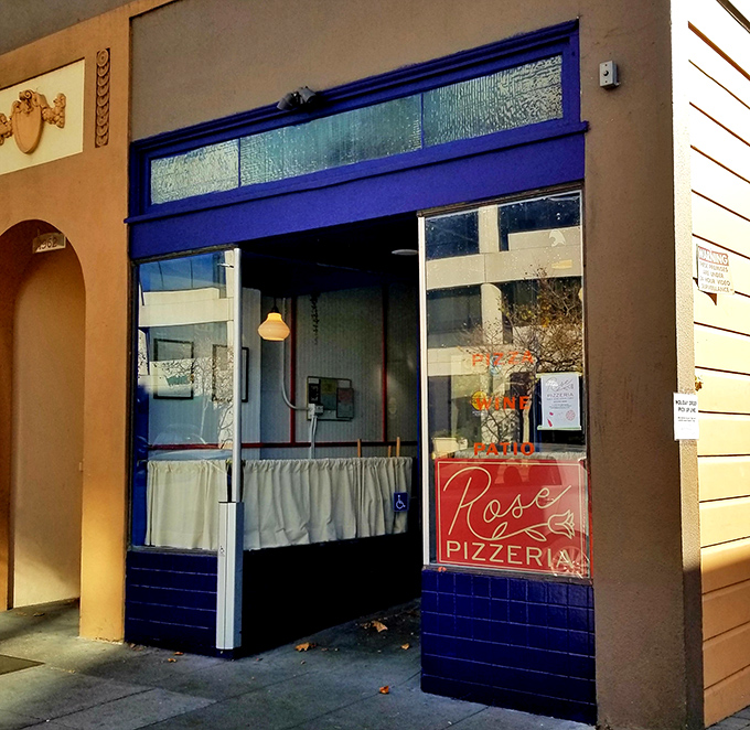 The unassuming blue-trimmed storefront of Rose Pizzeria might not scream for attention, but trust me&mdash;pizza paradise awaits behind that modest fa&ccedil;ade.