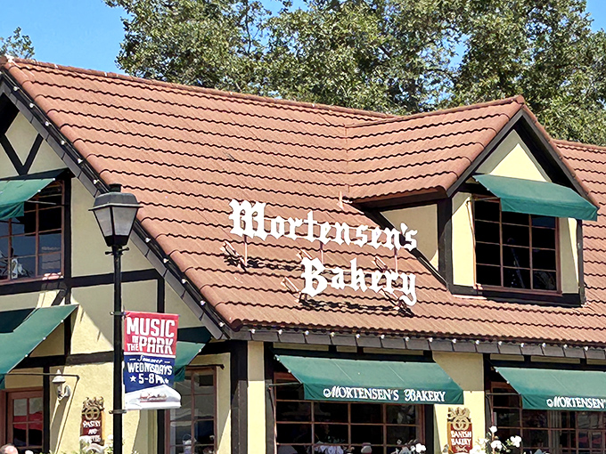 Mortensen's iconic yellow and timber-framed exterior stands as a beacon of Danish tradition in Solvang, promising buttery delights beneath that distinctive terracotta roof.