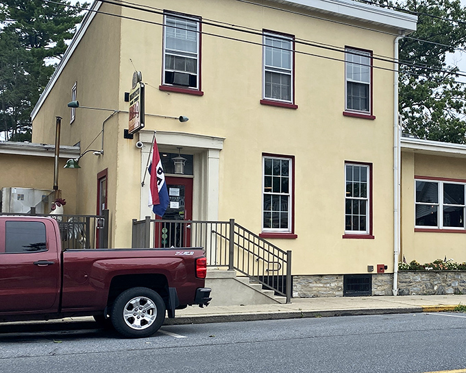 The bright yellow exterior of Harvey's Main Street BBQ announces itself with a banner that doesn't mince words: "The pig is cooking." Truth in advertising at its finest!