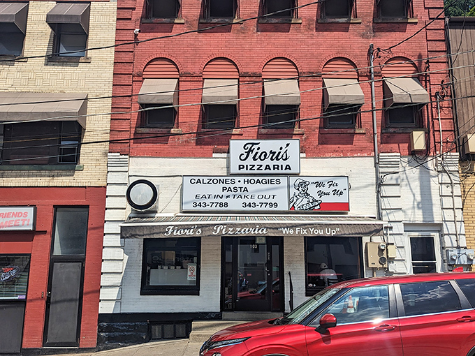 The modest storefront glows like a beacon in the night, promising salvation for the hungry with its straightforward motto: "We Fix You Up."