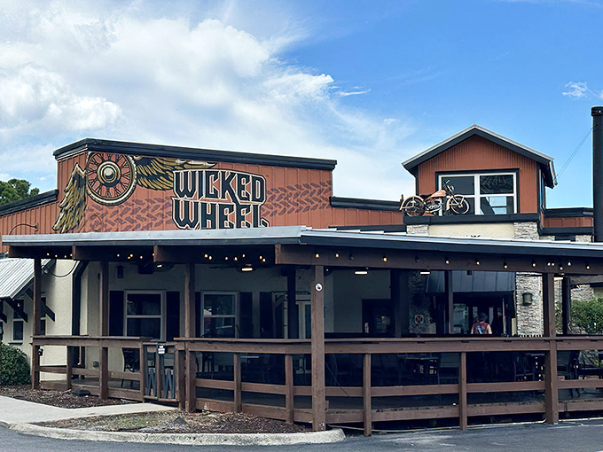 The Wicked Wheel's exterior promises adventure with its winged logo and rustic charm. Motorcycle theme outside, culinary magic inside.