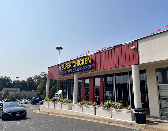 The crimson facade of Super Chicken stands out like a beacon of culinary promise in Vienna's retail landscape. Peruvian rotisserie excellence awaits inside.