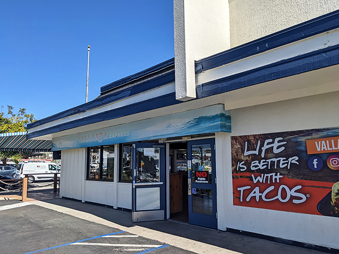 The blue and yellow beacon of Vallarta Express stands proud on Garnet Avenue, promising 24/7 Mexican food salvation for hungry San Diegans.