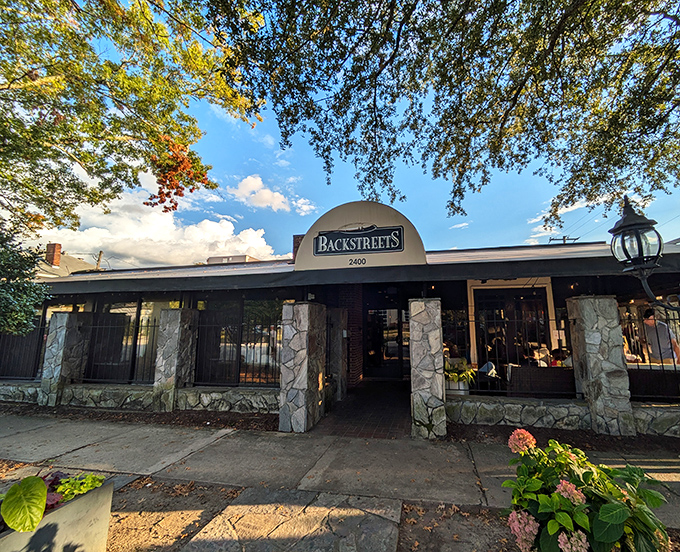 The stone facade entrance to Backstreets Grill stands like a culinary fortress, promising comfort and flavor beneath that iconic arched sign.