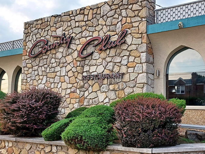 The iconic stone facade of Country Club Diner welcomes hungry Philadelphians with its elegant script signage and meticulously maintained landscaping.