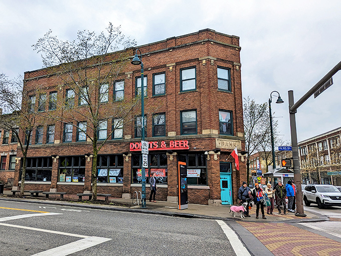 The historic brick building proudly announces its mission with glowing pink letters: DONUTS & BEER. That turquoise door is basically a portal to happiness.