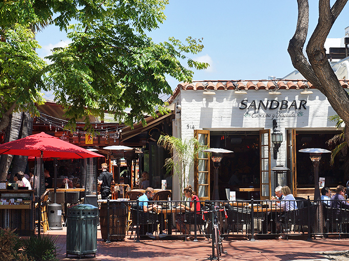 Santa Barbara's architectural charm meets culinary magic at Sandbar's inviting patio. Those leafy trees aren't just for show—they're nature's air conditioning for your taco enjoyment.