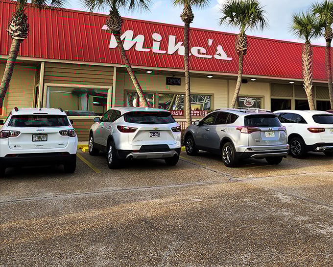 Mike's distinctive red roof and palm trees stand like beacons for seafood lovers, promising treasures that the unassuming exterior only hints at.