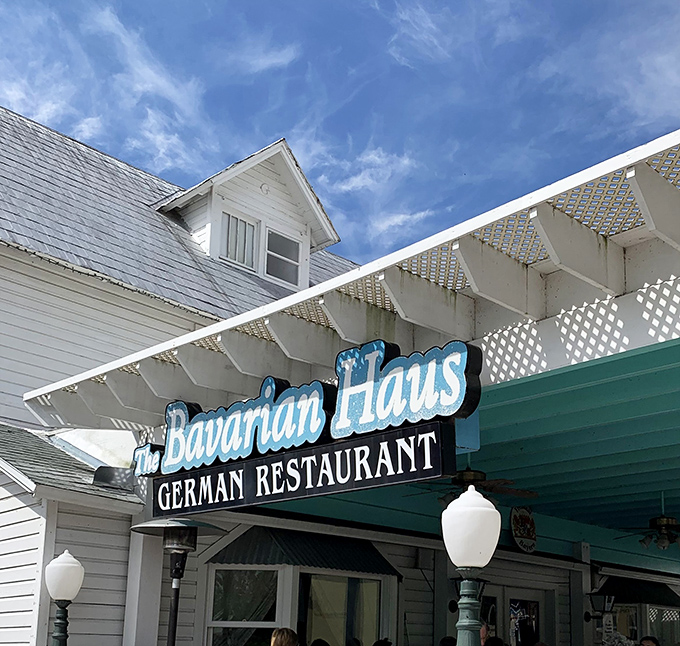 The teal-trimmed facade of The Bavarian Haus stands like a cheerful Alpine postcard against Florida's blue skies, promising authentic German flavors in Mount Dora.