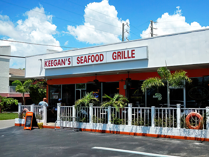 The unassuming exterior of Keegan's Seafood Grille proves once again that Florida's best seafood treasures don't need flashy facades—just those inviting blue umbrellas beckoning you inside.