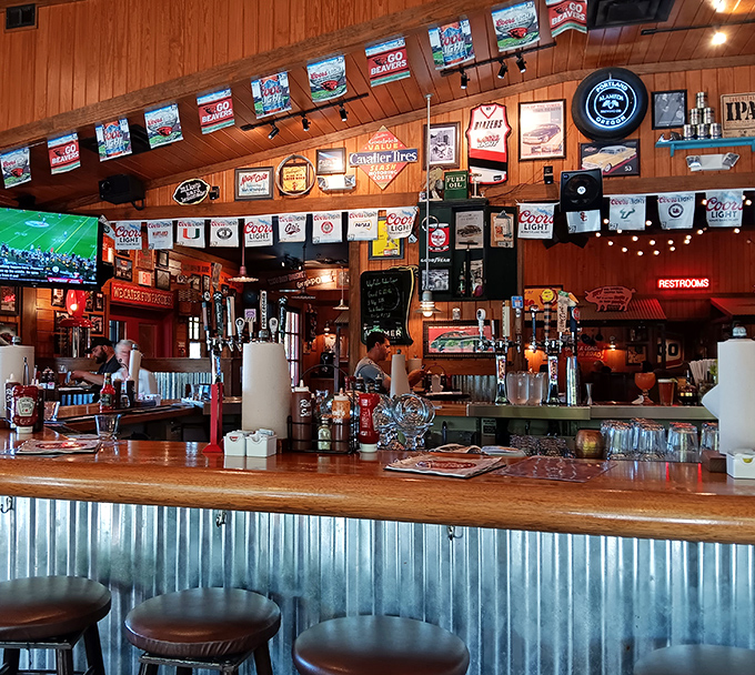 The bar at Famous Dave's &ndash; where cold drinks flow freely and the rustic wood-paneled walls tell stories of barbecue adventures past.