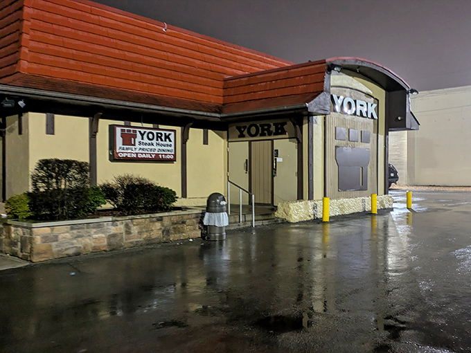 The iconic red-roofed York Steak House stands like a culinary time capsule in Columbus, beckoning hungry patrons with its nostalgic charm and promise of sizzling steaks.