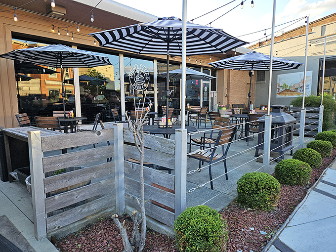 The patio at Homestead beckons with its striped umbrellas and rustic wooden dividers &ndash; like a stylish backyard BBQ where everyone's invited.